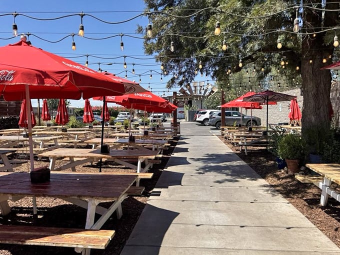 String lights, picnic tables, and Arizona sky—the outdoor dining area feels like the world's best backyard barbecue that you're actually invited to.