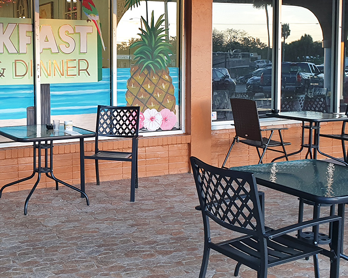 Outdoor seating with tropical flair. That pineapple mural isn't just decoration—it's a promise of the sweet experience waiting inside.
