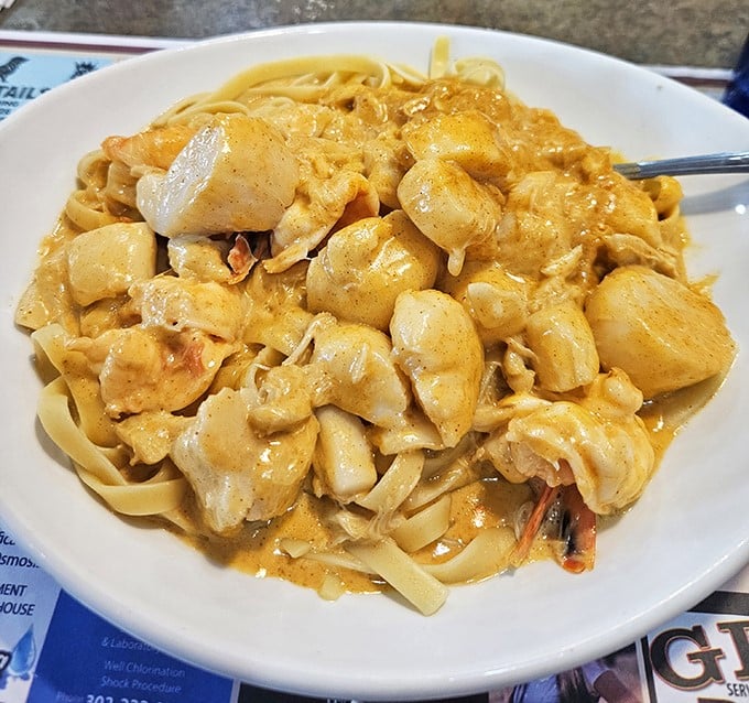 Seafood pasta swimming in golden sauce – proof that Delaware's proximity to water translates directly to deliciousness on your plate.