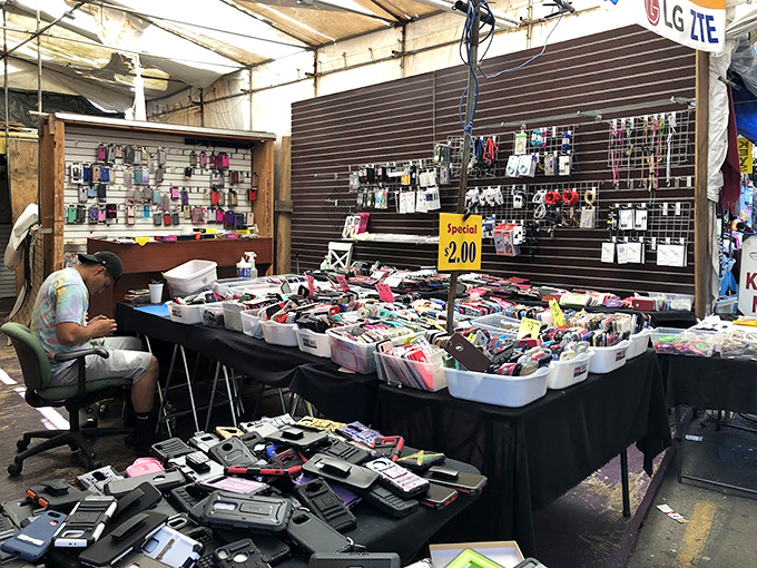 The modern bazaar in action—where vendors transform simple tables into organized displays of phone cases, creating a tech accessory rainbow. 