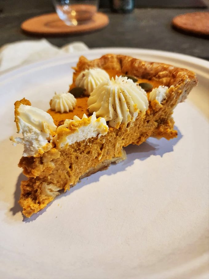 A slice of pumpkin pie that would make grandmothers nervous. Those dollops of cream aren't decoration—they're essential supporting characters.