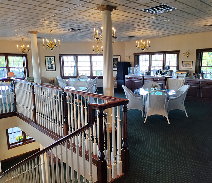 The second-floor dining area combines elegance with country charm – chandeliers and white wicker create an atmosphere where lingering over coffee feels mandatory.