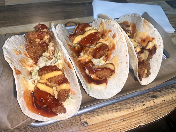 Three shrimp tacos standing at attention, ready to transport your taste buds somewhere sunny and satisfying.