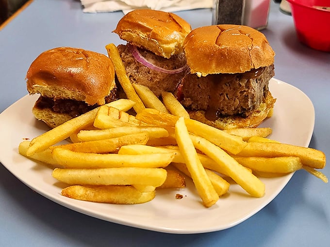 Three perfectly proportioned sliders standing at attention next to golden fries—proof that good things really do come in small packages.