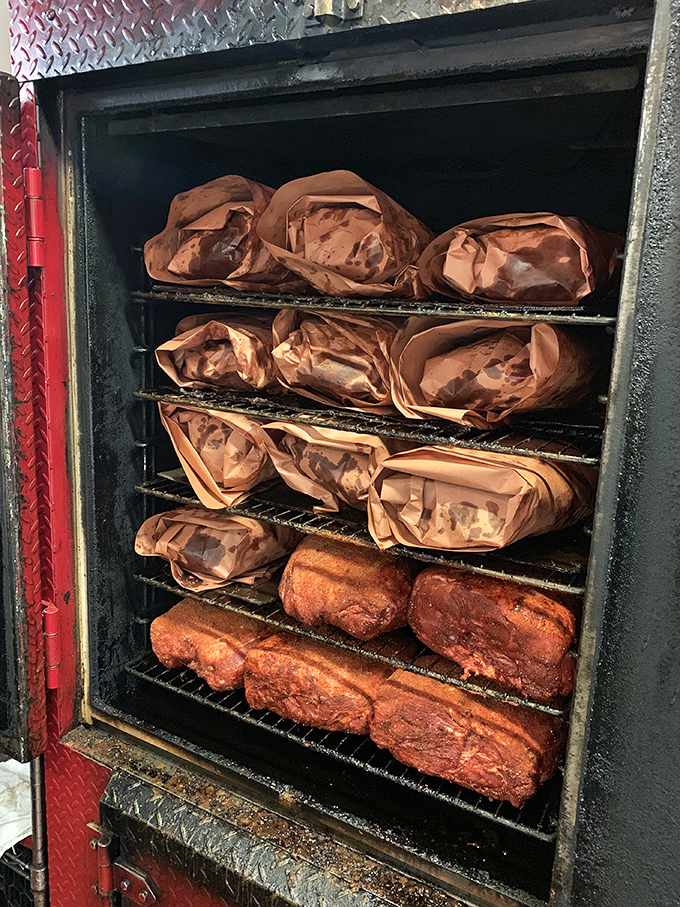 The smoker—where meat dreams come true. Those wrapped packages are like Christmas presents for your taste buds, just waiting to be unwrapped.