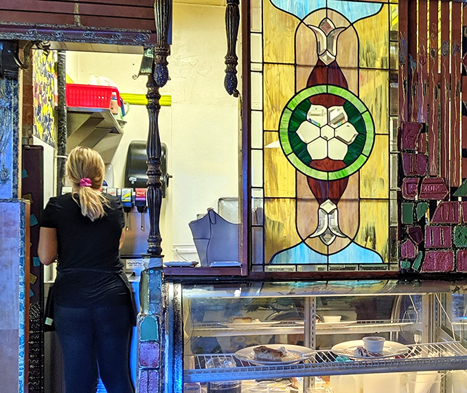 Beautiful stained glass divides dining spaces while letting light play throughout the room. The craftsmanship speaks to an attention to detail that extends to every plate.