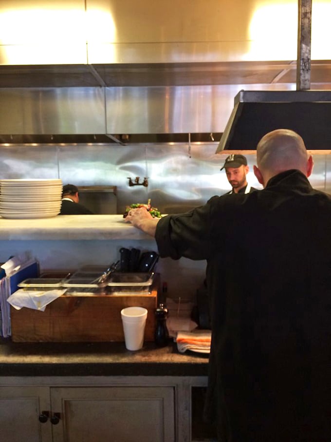 Behind the scenes, where culinary magic happens with focused precision—like watching Olympic athletes, but with better snacks.