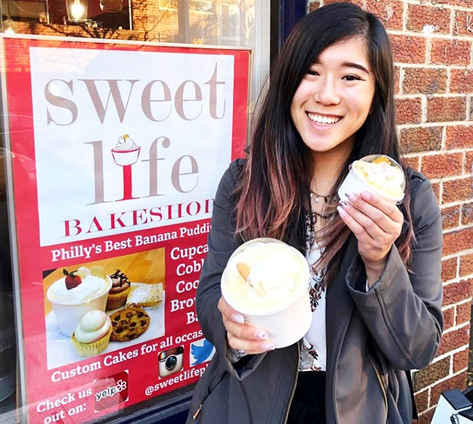 The universal expression of dessert joy—holding not one but two containers of banana pudding while standing outside the bakery, because waiting until you get home isn't an option.