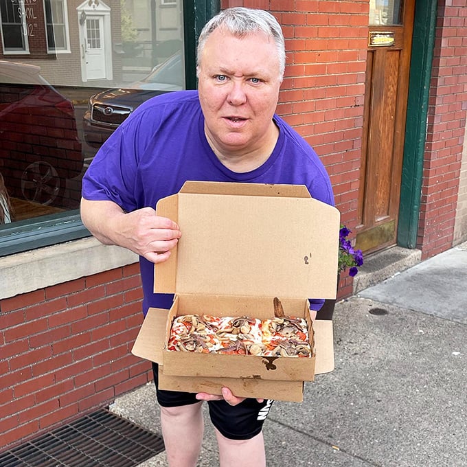 The true mark of pizza greatness? When customers look this happy just carrying out their boxed treasures, anticipation building with every step.