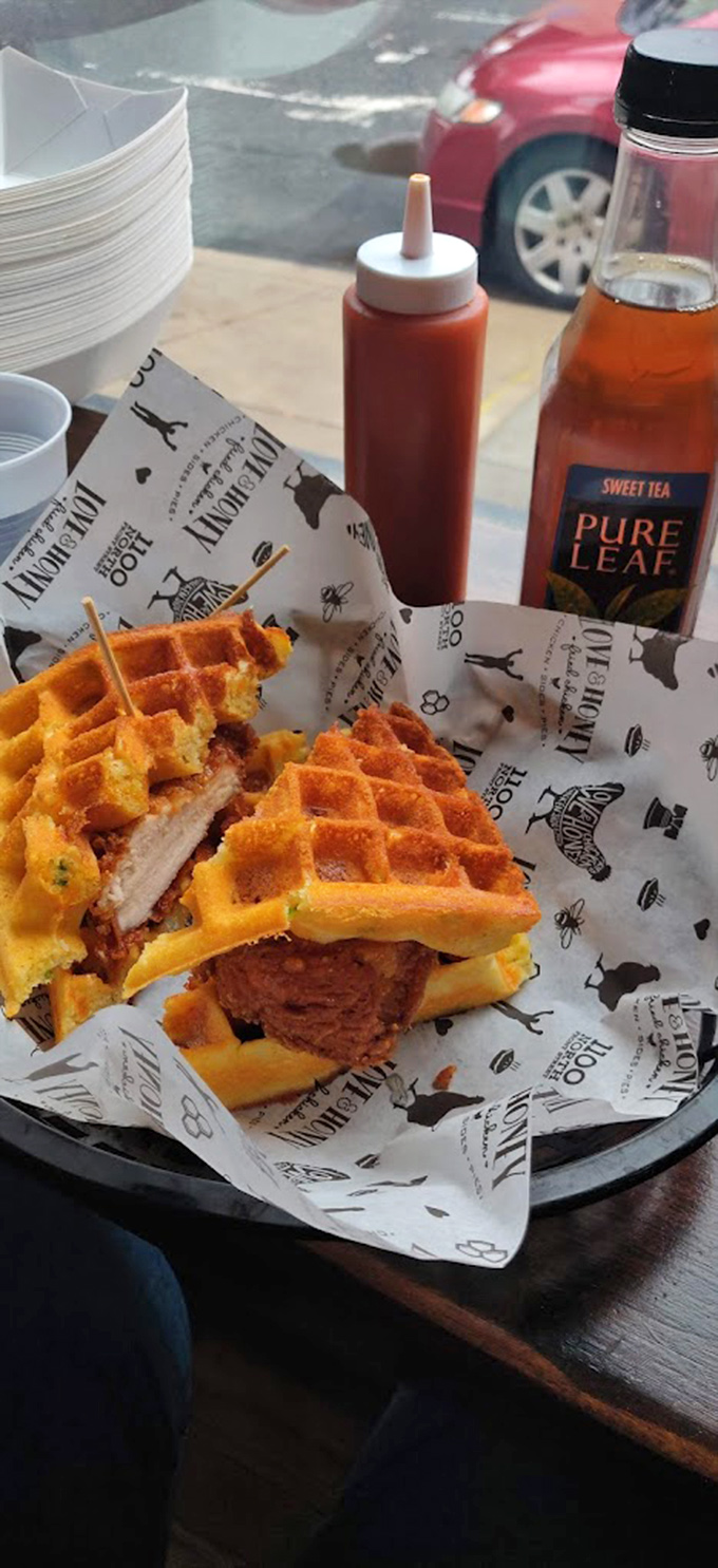 Chicken and waffles reimagined—crispy fried chicken nestled between golden waffles. Breakfast? Lunch? The only label it needs is "delicious."