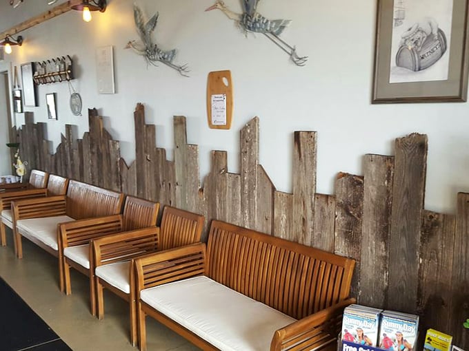 Weathered wood paneling and metal herons on the wall – Florida dining décor that says "we care more about what's on your plate than what's on our walls."