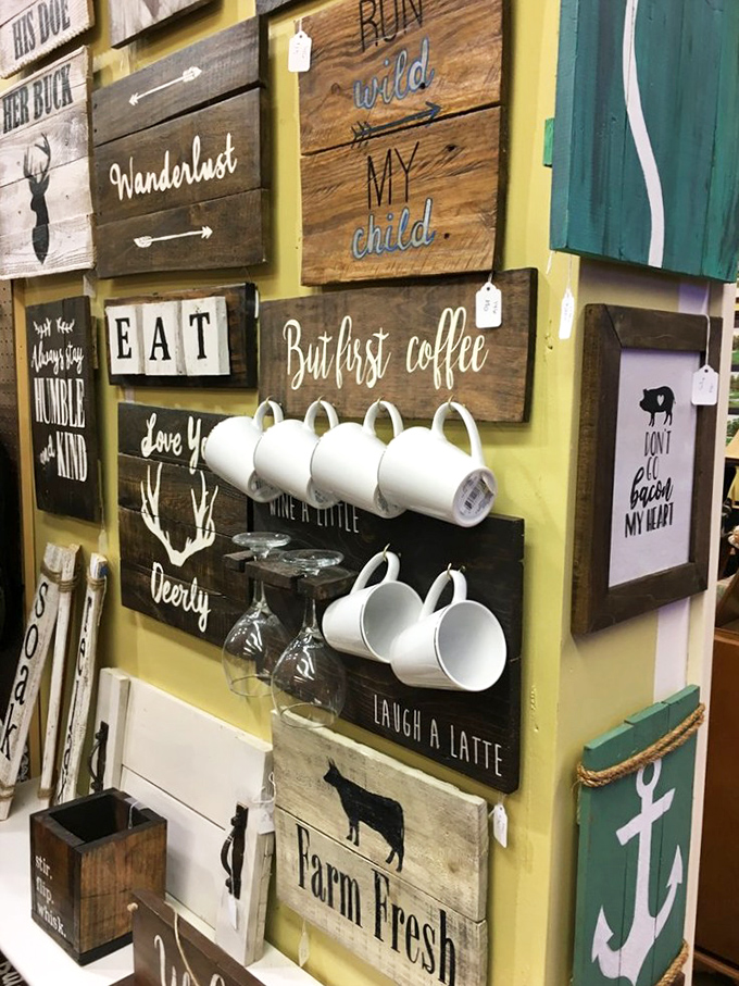Coffee mugs hanging like trophies on rustic wood signs—proof that even everyday objects become art in the right hands.