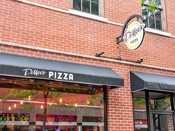 DiMeo's circular sign swings with urban pizza promise. That black awning isn't just stylish—it's sheltering sidewalk pizza dreams.