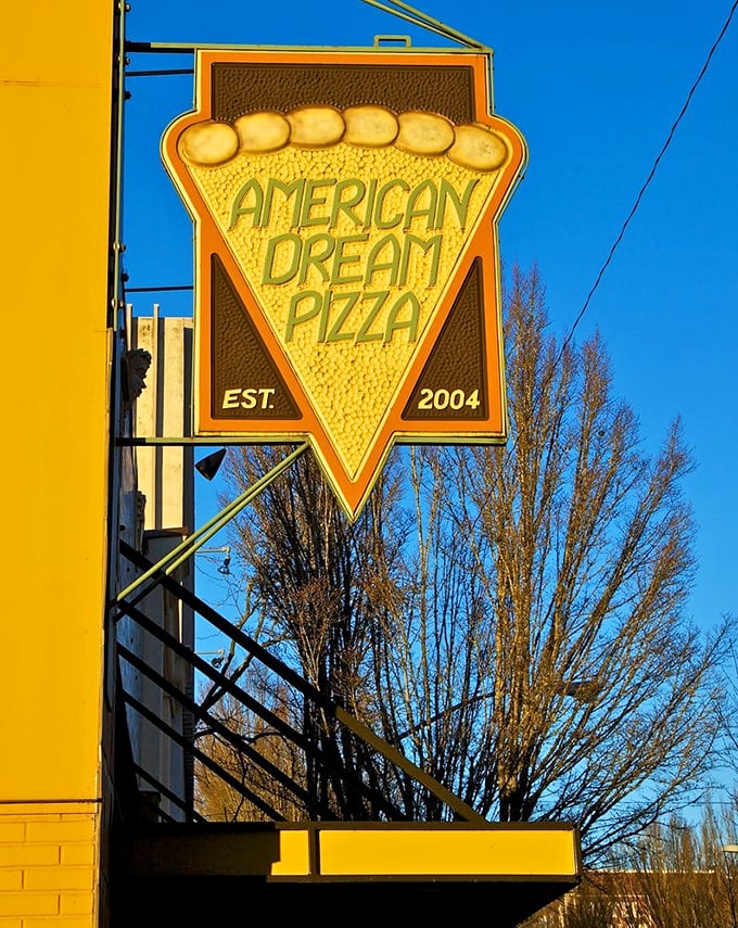 The sign says it all—a perfect triangle of cheesy goodness that's been fulfilling Corvallis dreams since 2004.