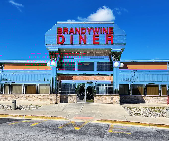 That classic diner silhouette against the blue sky? It's practically the official logo of "burgers done right."