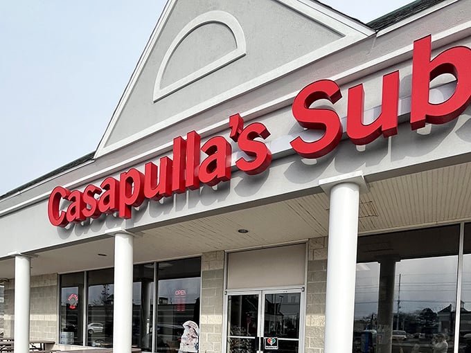 The red Casapulla's sign pops against the clean white exterior – a colorful promise of the flavor explosion waiting inside.