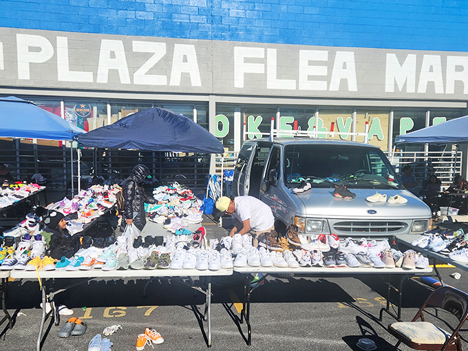 Vendors carefully arrange their footwear inventory at North Point Plaza. A shoe department where haggling is encouraged!
