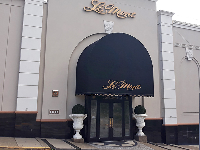 Le Mont's elegant exterior promises what awaits inside – a navy blue awning and classic architecture that whispers, "Yes, tonight is special."