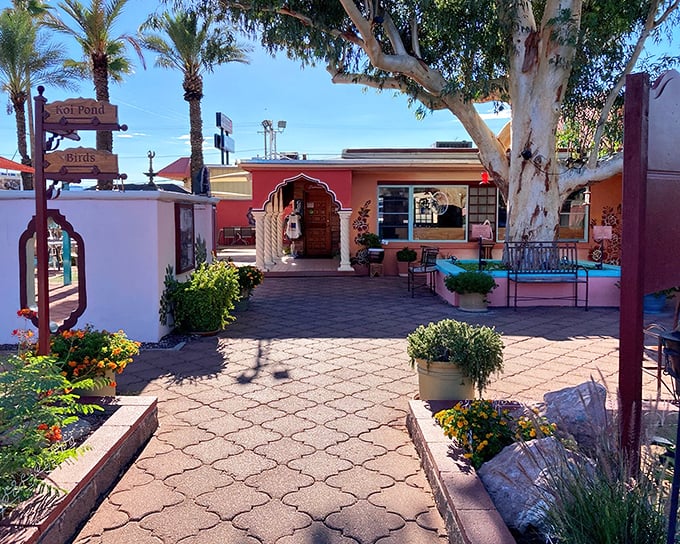 The entrance to Govinda's feels like stepping into a secret garden oasis, complete with desert blooms and a welcoming archway that promises culinary adventures ahead.