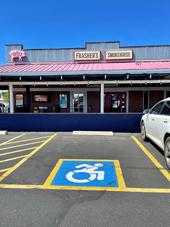 That corrugated metal roof and pink pig sign tell you everything you need to know—this place means business about its BBQ.