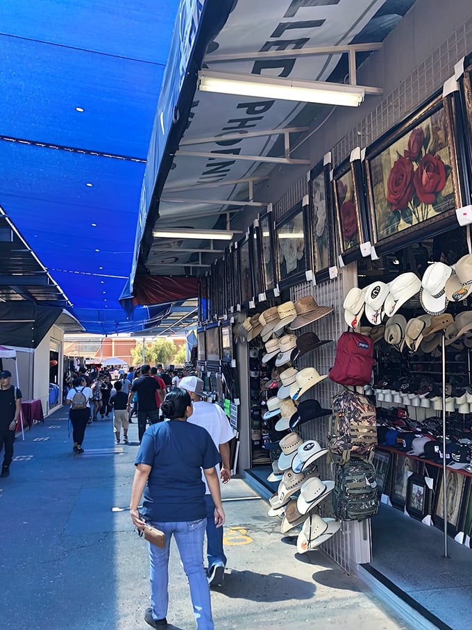 Treasure hunting begins at this vendor's stall, where cowboy hats and framed artwork await their next adventure in homes across the Arizona desert.