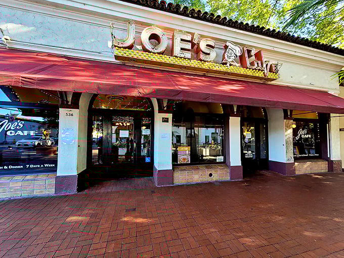 The iconic red awning of Joe's Café beckons hungry travelers like a culinary lighthouse on Santa Barbara's State Street.