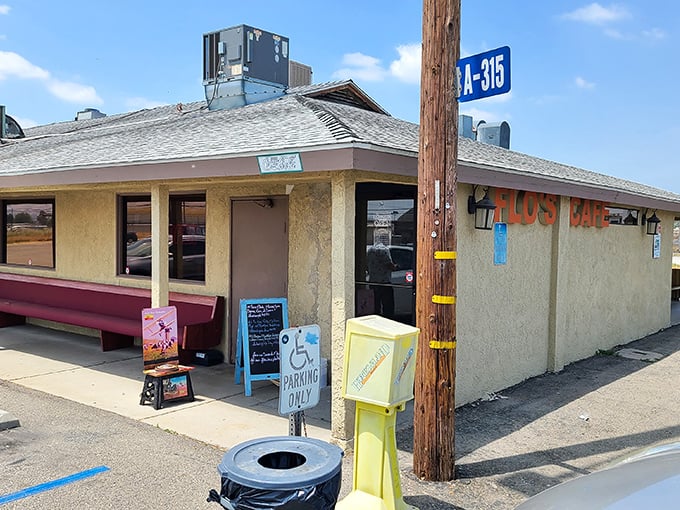 The unassuming exterior of Flo's Airport Cafe stands like a culinary control tower, guiding hungry travelers to a runway of flavor at Chino Airport.