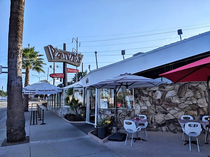 Pann's iconic neon sign beckons like a mid-century lighthouse, promising comfort food salvation just minutes from LAX's chaos.