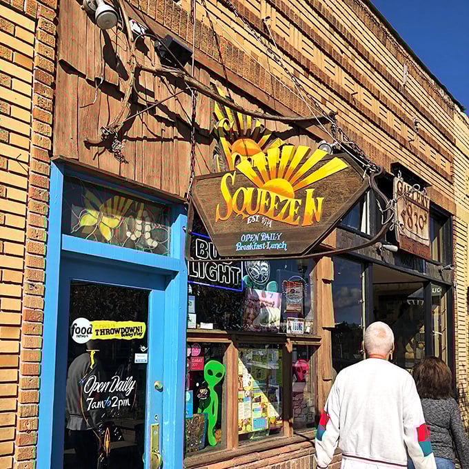Squeeze In's iconic sunburst sign hangs proudly above the entrance, promising cosmic breakfast adventures to hungry travelers and locals alike.