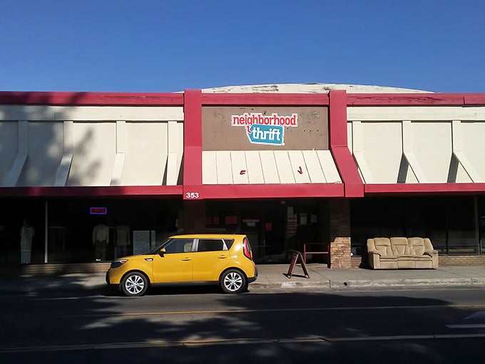 The distinctive red-trimmed facade of Neighborhood Thrift stands out against the Fresno sky, beckoning bargain hunters with promises of hidden treasures.