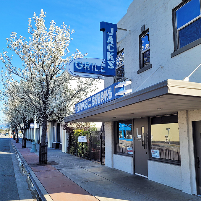 That vintage neon glow says everything about Jack's Grill – authentically timeless steakhouse magic awaits inside.