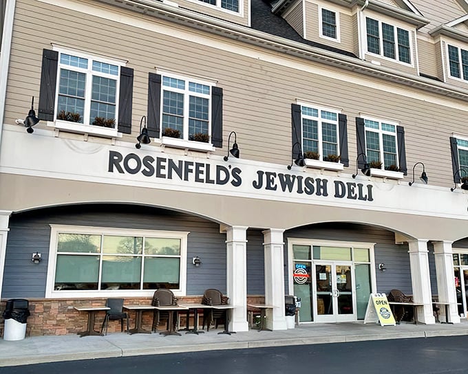 The classic blue awning and gray clapboard exterior of Rosenfeld's Jewish Deli stands as a beacon of comfort food in Rehoboth Beach.