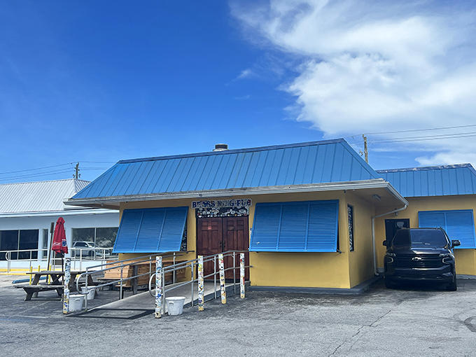 The unassuming yellow exterior with bright blue trim might fool you, but locals know this modest building houses wing perfection. Florida's best-kept culinary secret hides in plain sight.