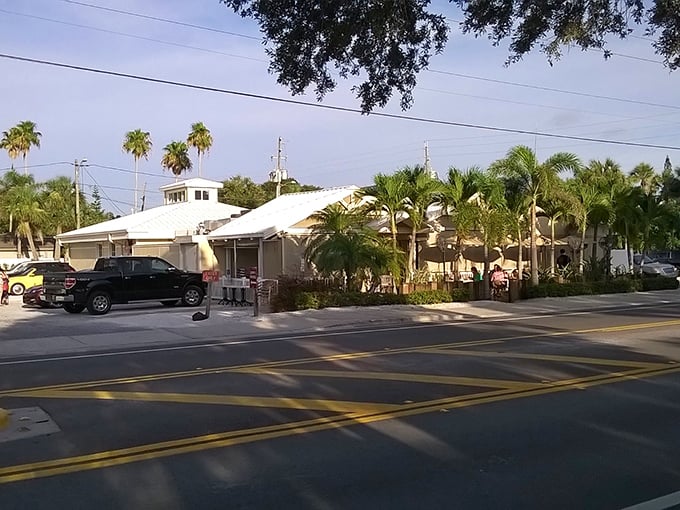 The classic Florida beach architecture of Guppy's welcomes hungry visitors with its white roof and lush tropical landscaping—a postcard-perfect coastal dining destination.