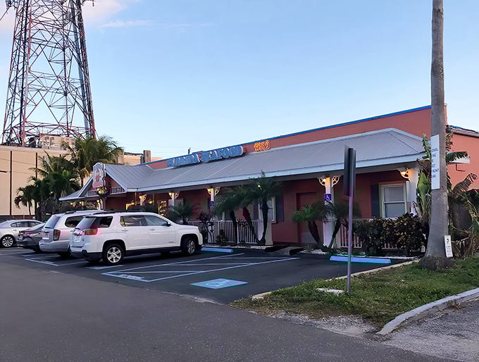 match the caption to the image :The bearded fisherman on the sign seems to say, "Trust me, I know where the good stuff is." Florida's Seafood's coral exterior promises coastal delights inside.