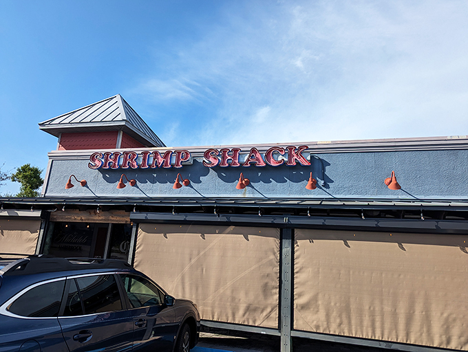 The unassuming exterior of Shrimp Shack belies the seafood treasures within. That drive-thru sign? A blessing for those days when pants feel optional.