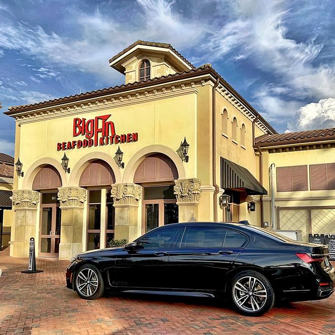 The Mediterranean-inspired façade of Big Fin Seafood beckons like a coastal oasis amid Orlando's sea of theme park dining options.