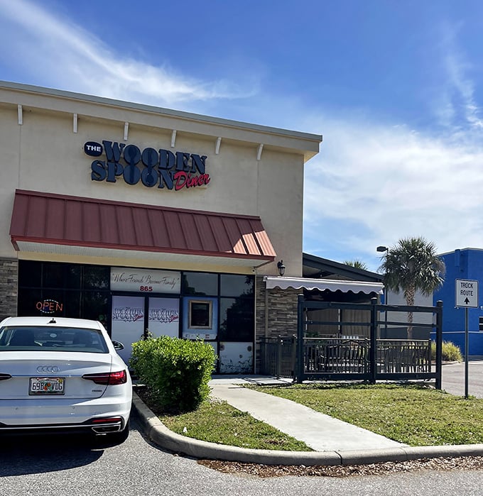 Florida sunshine illuminates The Wooden Spoon's façade, where palm trees stand guard over one of Brandon's most cherished breakfast institutions.