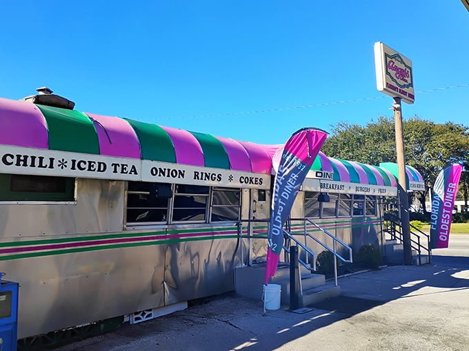 The pink and green striped awning of Angel's Dining Car isn't just eye-catching—it's a beacon of hope for hungry travelers who know what culinary treasures await inside.