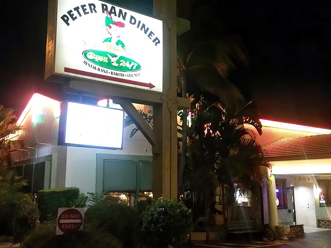By night, the illuminated Peter Pan Diner sign transforms into a beacon of comfort food possibilities, promising late-night sustenance when hunger strikes.