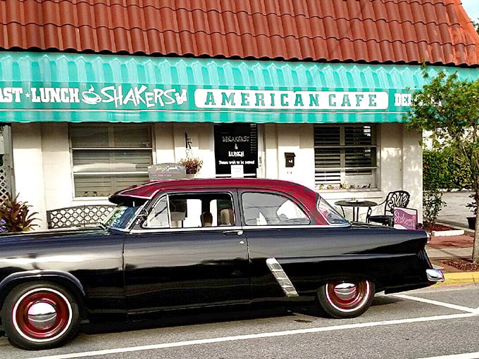 The classic turquoise awning and Spanish-tiled roof of Shakers American Café stands as a beacon for breakfast lovers. That vintage car isn't just for show—it's foreshadowing the timeless experience inside.