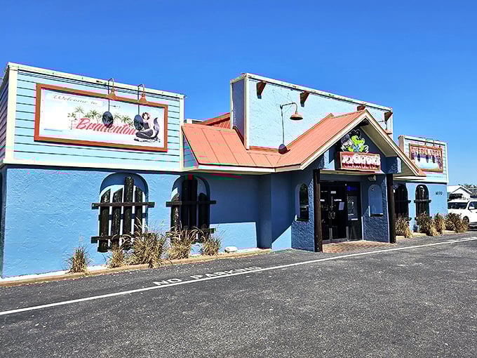 The turquoise blue exterior with coral roof isn't just Florida architecture—it's a promise of the coastal flavor fiesta waiting inside.