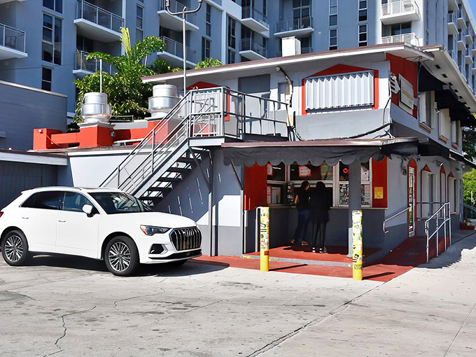Miami's skyline provides a dramatic backdrop to this unassuming culinary landmark, where luxury SUVs park alongside delivery trucks in democracy of deliciousness.