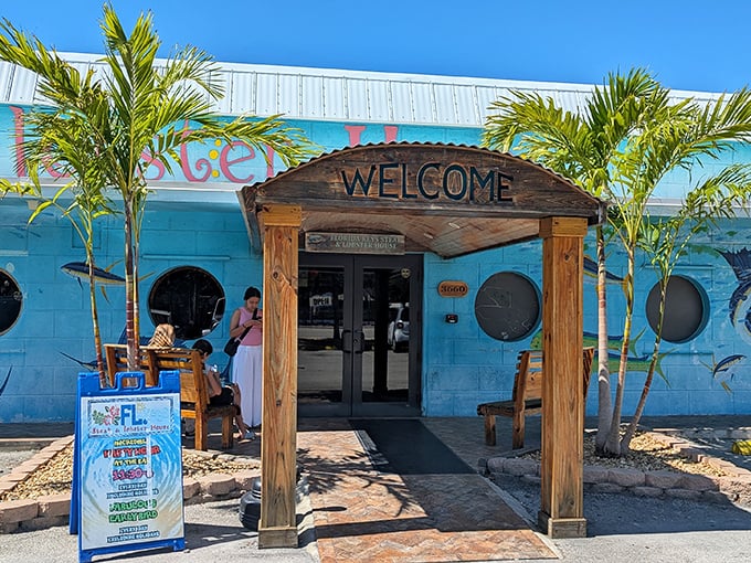 The turquoise beacon of culinary delight beckons with its wooden "WELCOME" sign – a humble entrance hiding extraordinary flavors within.