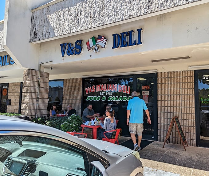 Those crossed Italian and American flags aren't just decoration—they're a promise of the cultural fusion waiting inside this beloved Boca Raton institution.