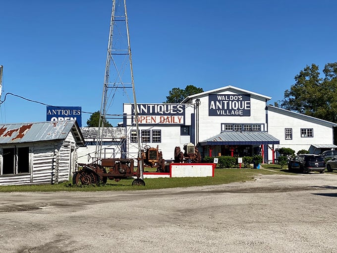 The white-washed charm of Waldo's Antique Village stands like a time machine in the Florida sun, complete with vintage farm equipment as lawn ornaments.
