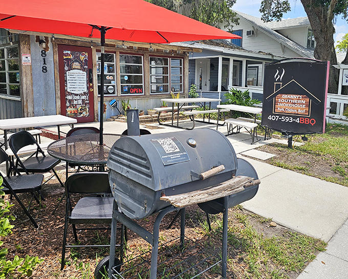 A bright red umbrella welcomes you like an old friend to this unassuming BBQ sanctuary. The smoker out front isn't just equipment—it's a promise.