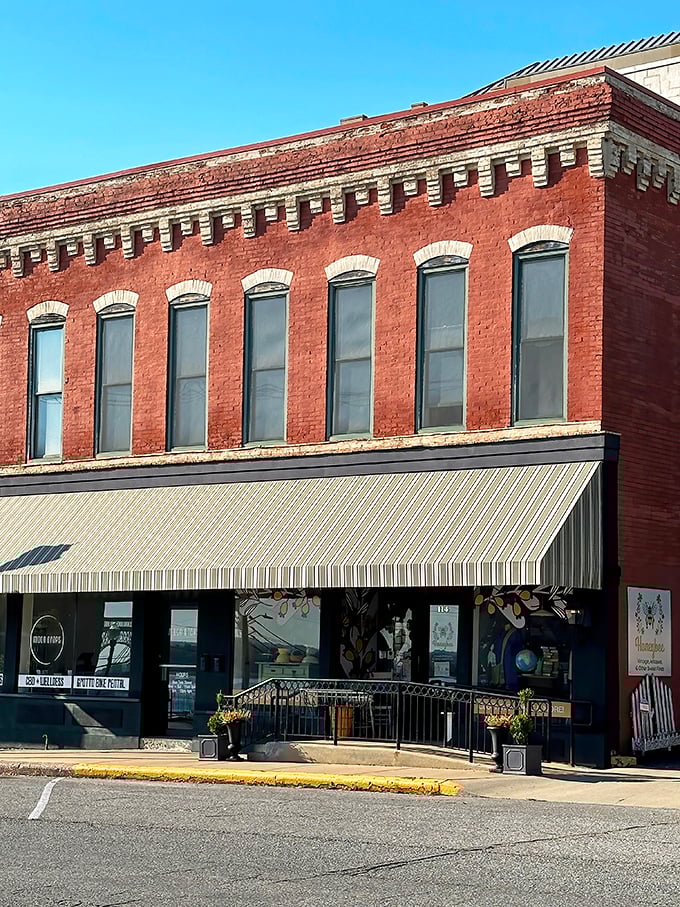 The historic brick façade of Honeybee Vintage stands proudly on Alton's main street, its striped awning like a welcome flag for treasure hunters.