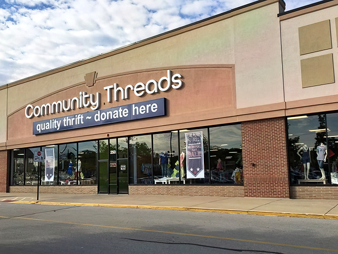 The welcoming storefront of Community Threads promises treasure hunting adventures with its clean, professional appearance and bright signage.