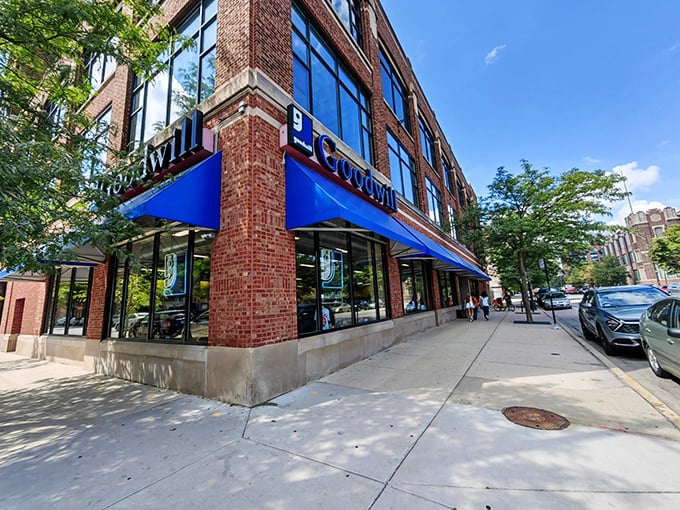 The iconic blue awning of Goodwill beckons bargain hunters like a retail lighthouse guiding ships to treasure-filled shores.